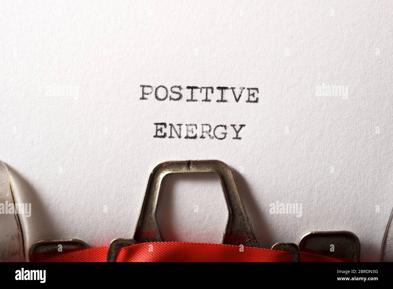 Positive energy text written with a typewriter Stock Photo - Alamy