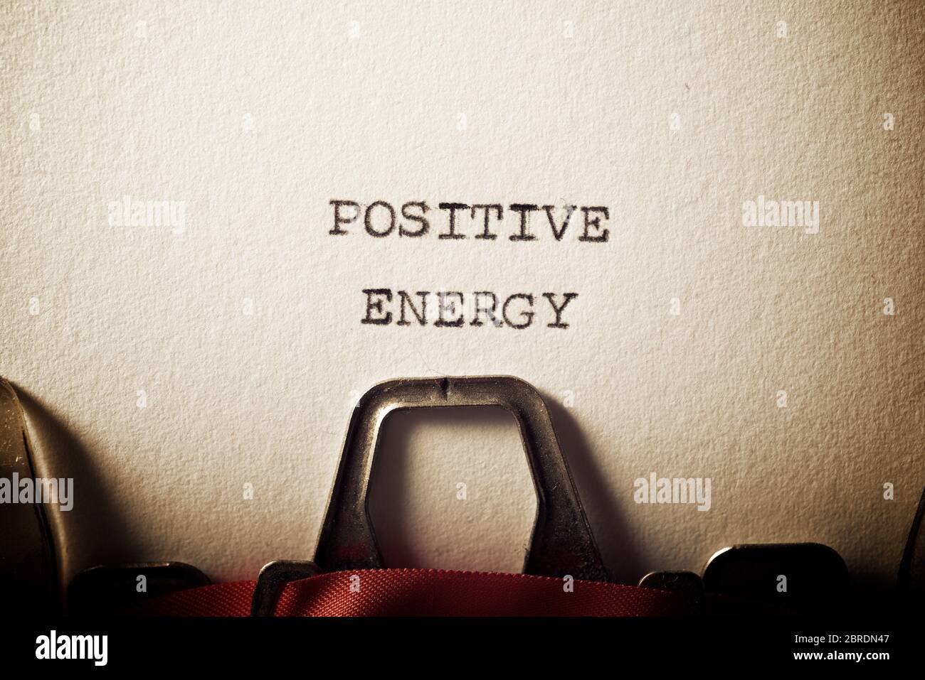 Positive energy text written with a typewriter Stock Photo - Alamy