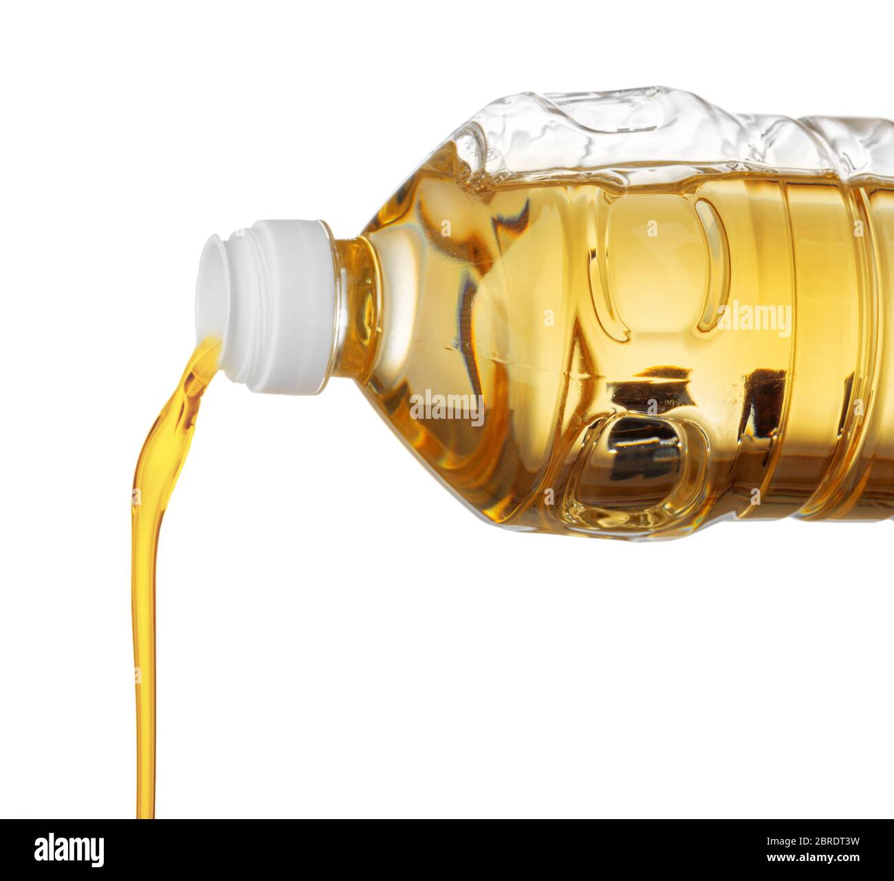 Pouring oil for cooking in a bottle isolated on white background Stock ...