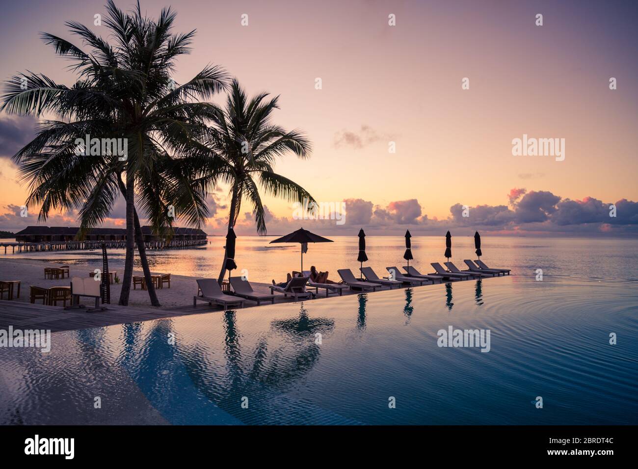 Beautiful poolside and sunset sky. Luxurious tropical beach landscape ...