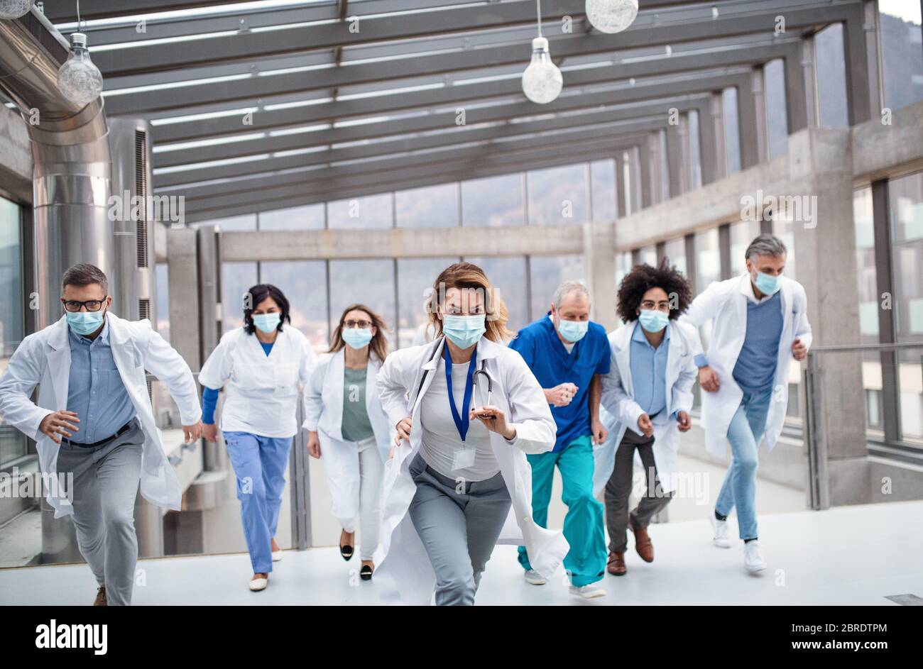 Group of doctors with face masks running, corona virus concept Stock ...