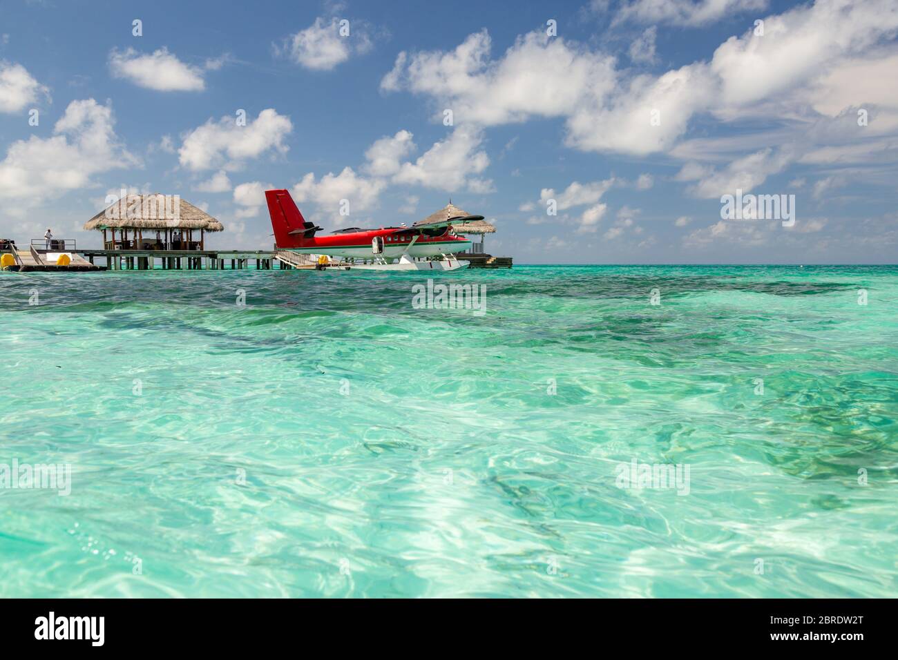 Seaplane at Maldives islands. Amazing blue lagoon, with red seaplane ...