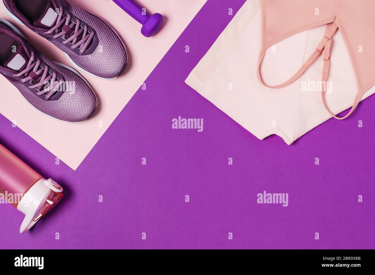 Sports equipment for training at home. Pink-purple background, diagonal ...