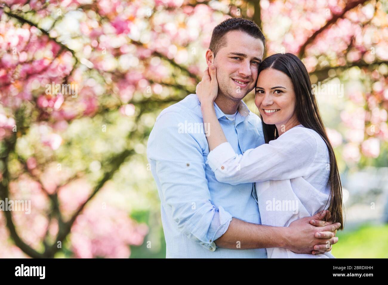 Woman standing tree park blooming hi-res stock photography and images ...