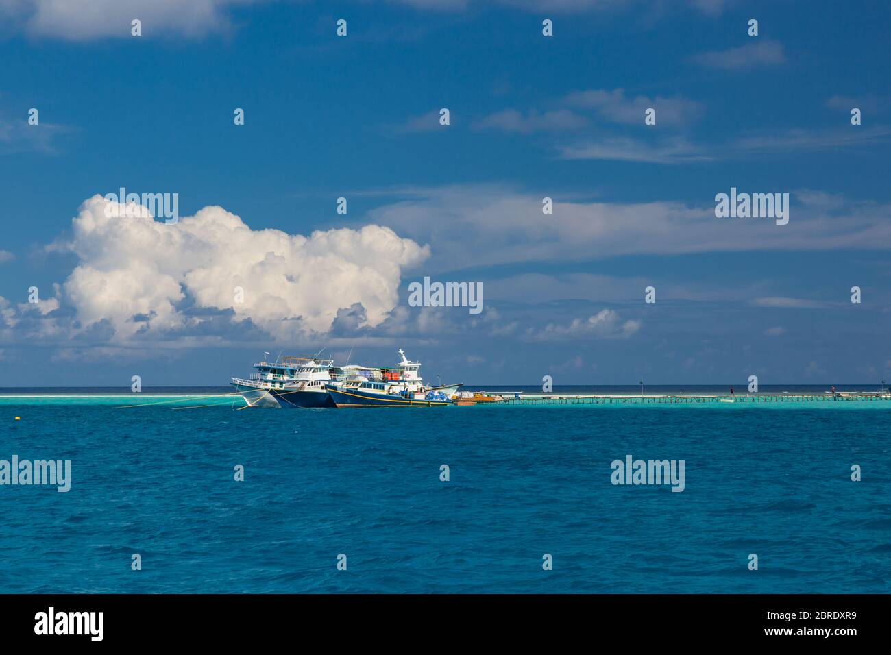 Fishing in the blue waters, tropical fishing boats over exotic lagoon ...