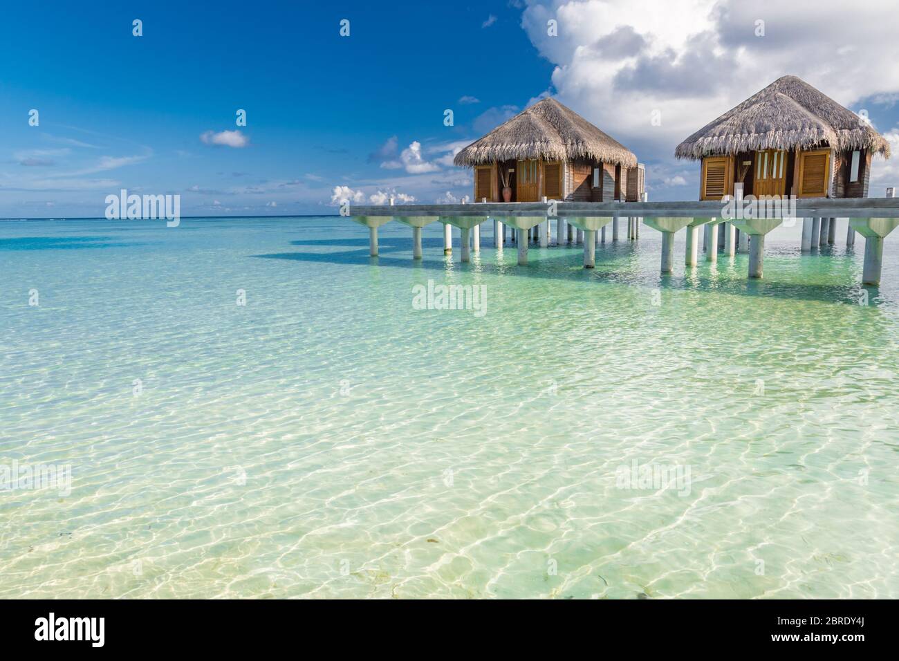 Tropical beach in Maldives with luxury over water bungalows or villas ...
