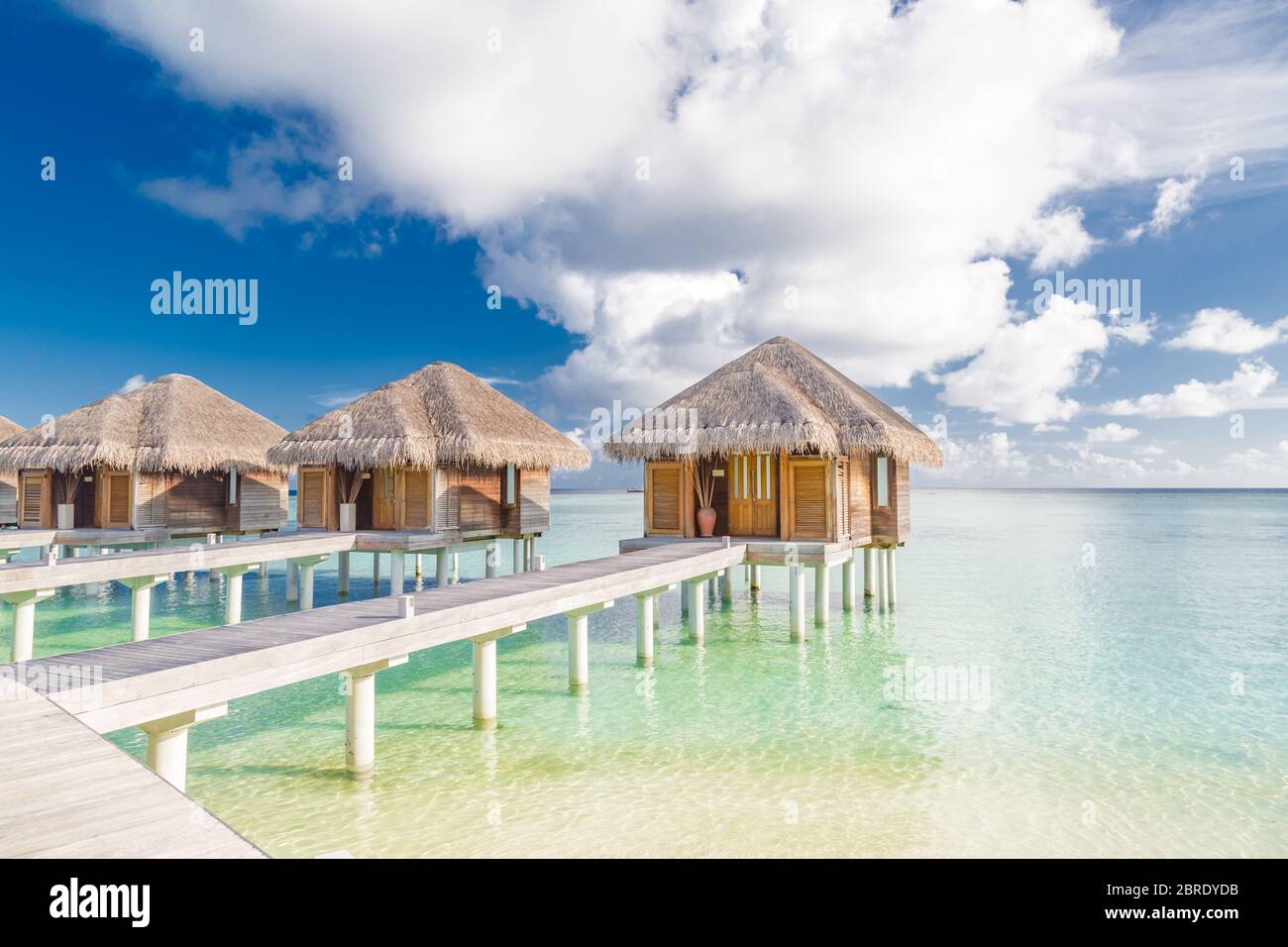 Tropical beach in Maldives with luxury over water bungalows or villas ...