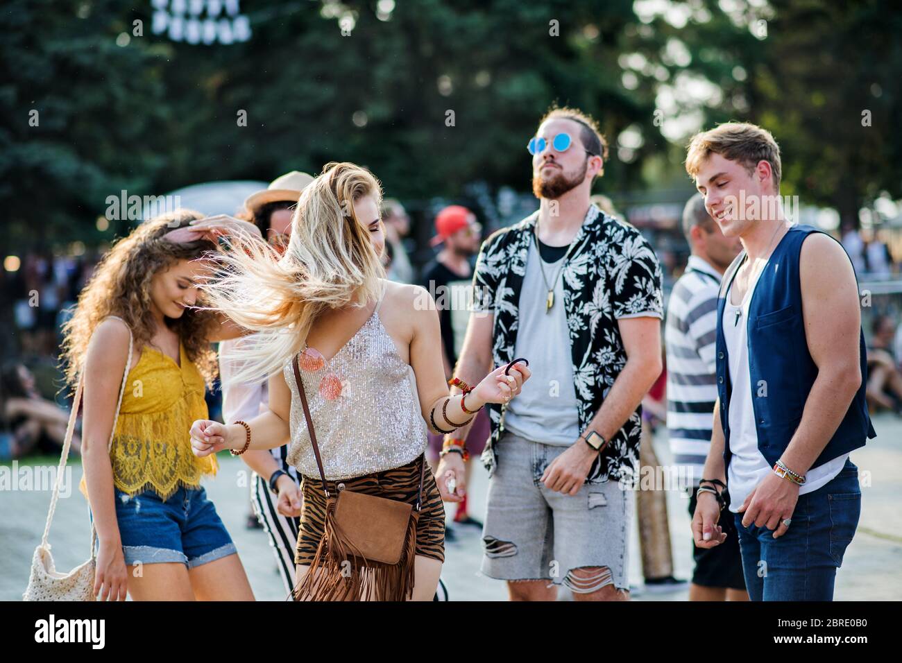Front view portrait of group of young friends dancing at summer ...