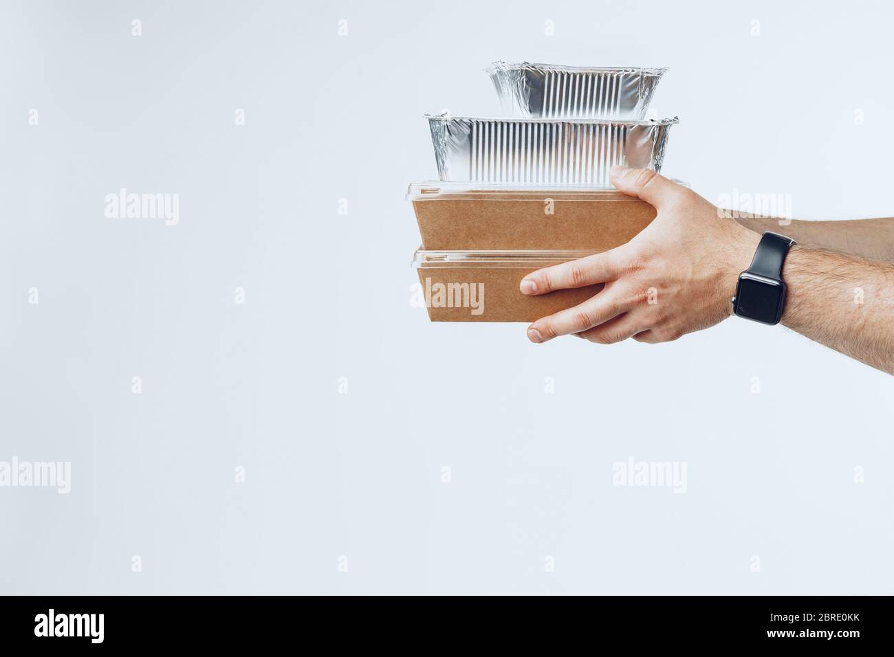 Courier hands giving packed food delivery close up Stock Photo - Alamy