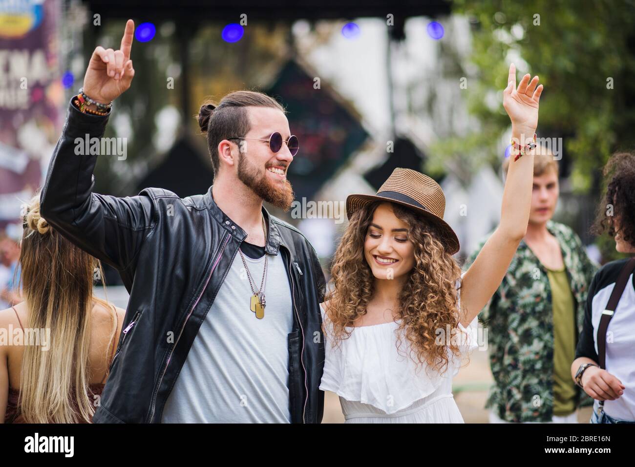 Young couple at summer festival, dancing arm in arm Stock Photo - Alamy