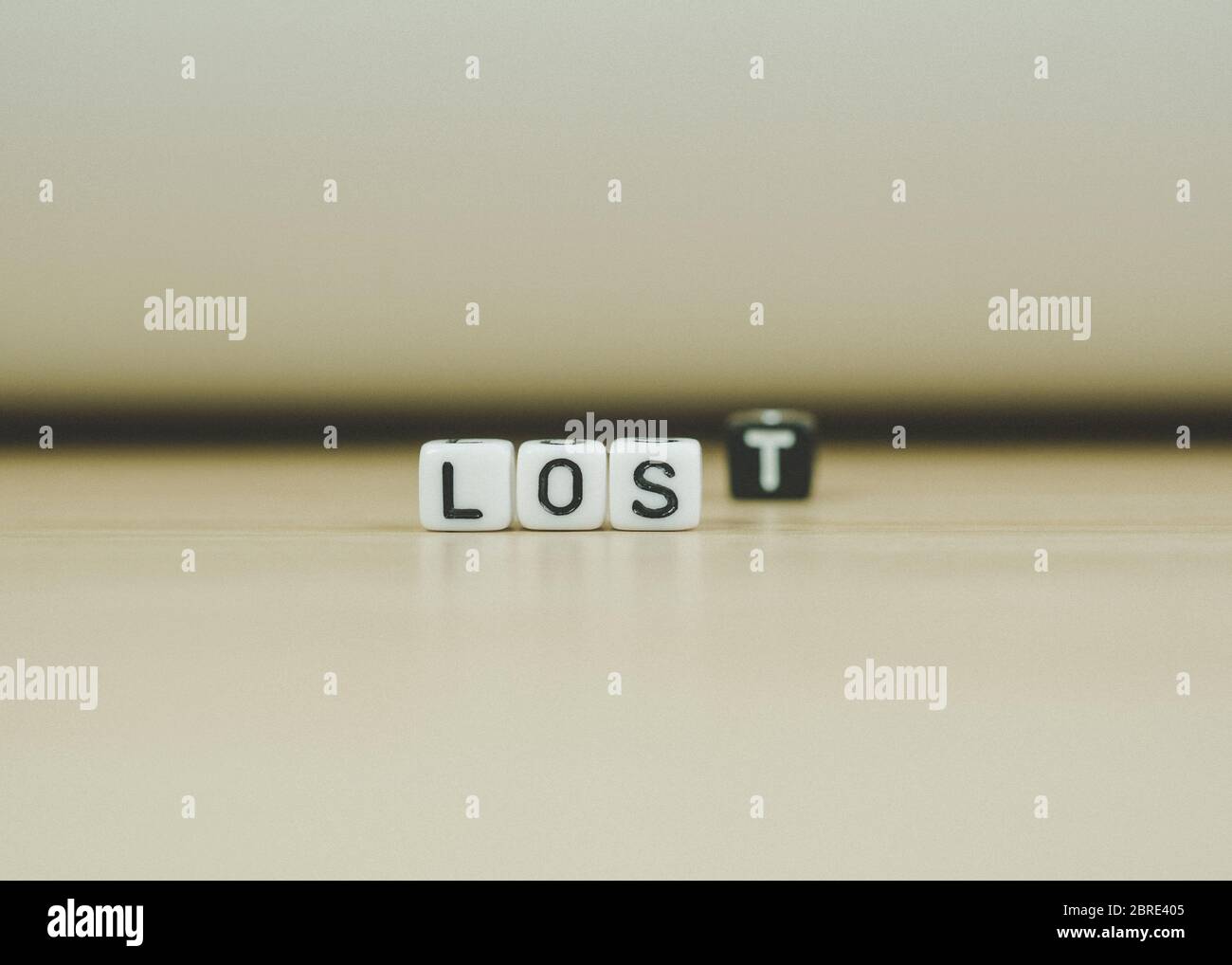 lost word written in cube on wooden floor on white background, letter ...