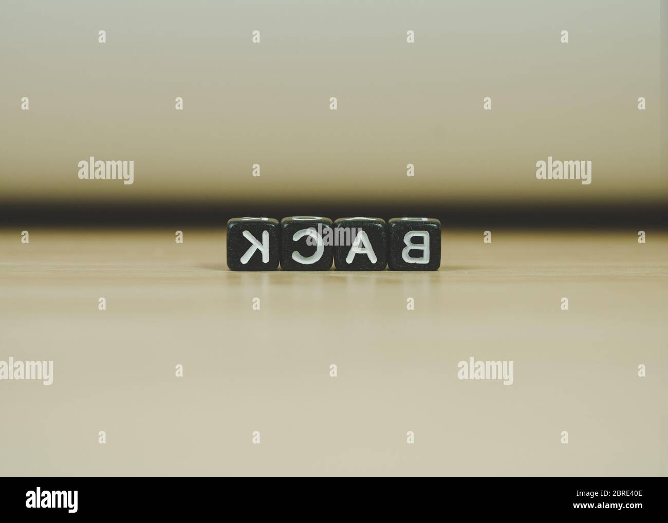 back word written in cube on wooden floor on white background, letter ...