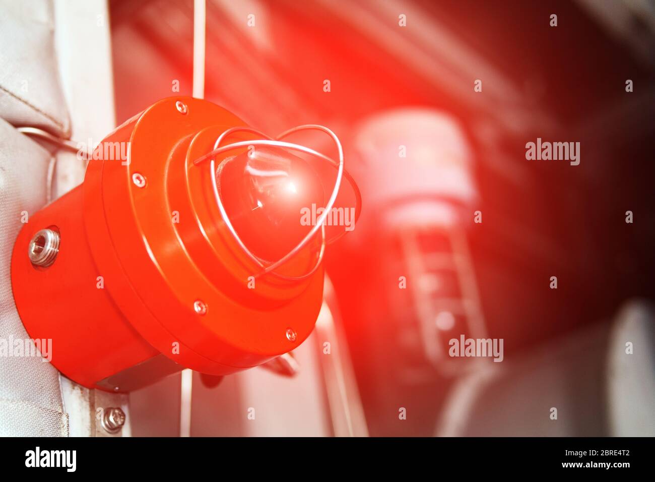 Fire alarm with red warning light of an emergency beacon at an ...