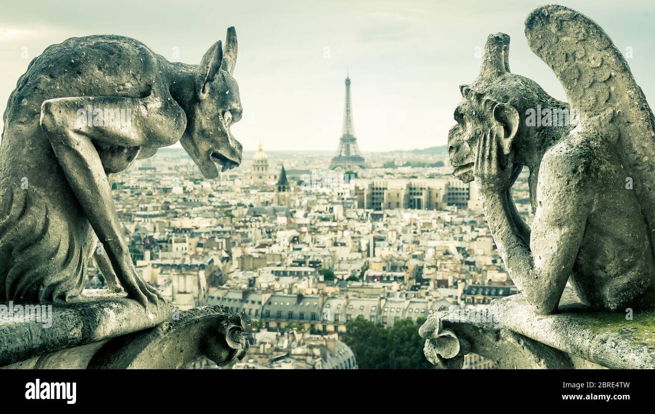 Gargoyles or chimeras on the Notre Dame de Paris overlooking the Paris city, France. Old ...