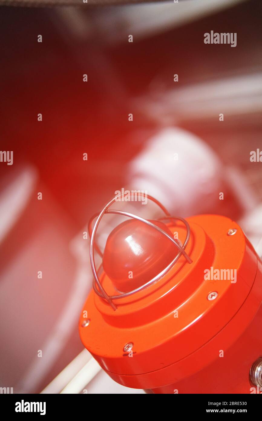 Fire alarm with red warning light of an emergency beacon at an ...