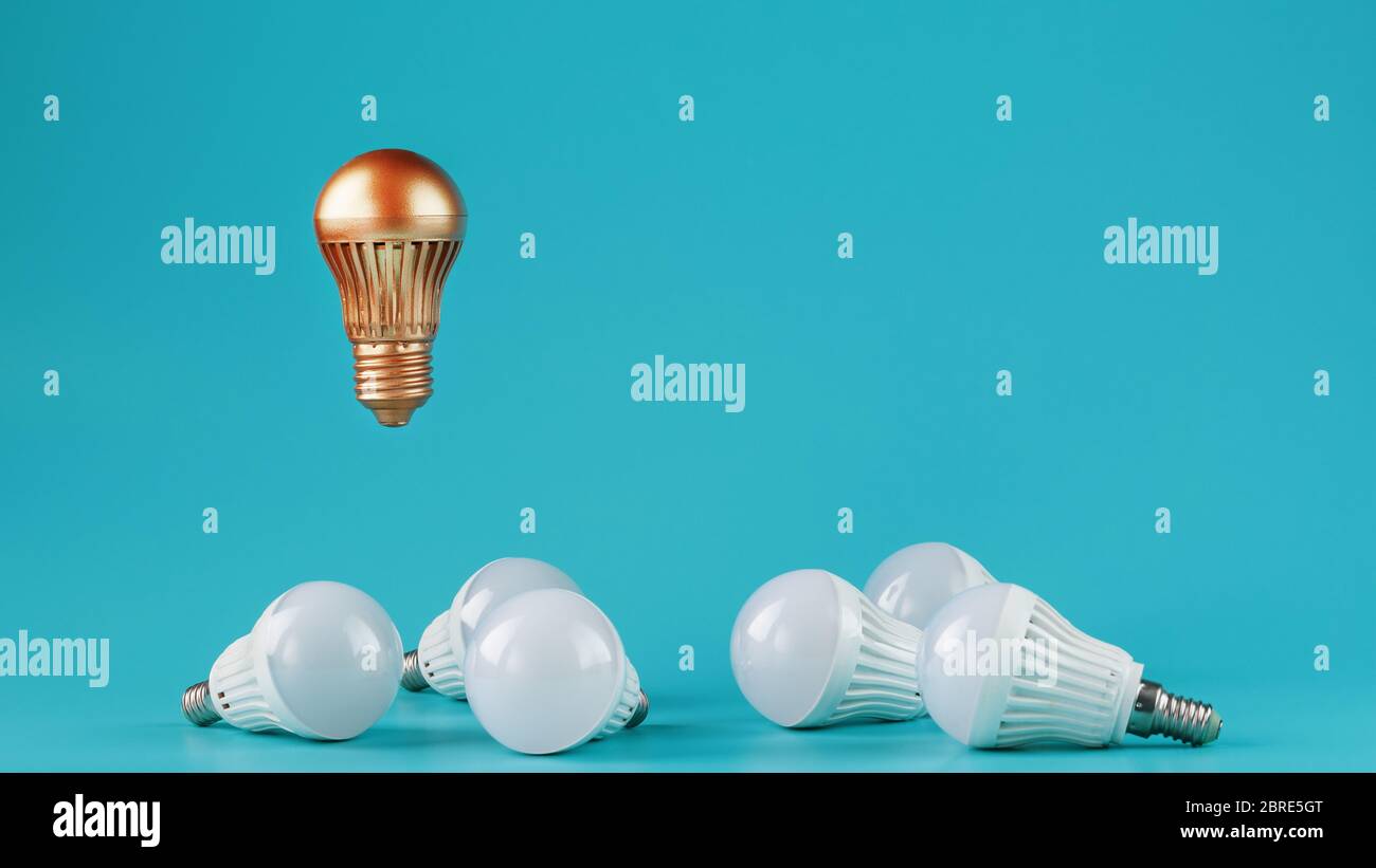 A prominent gold light bulb levitates above an environment of white led ...