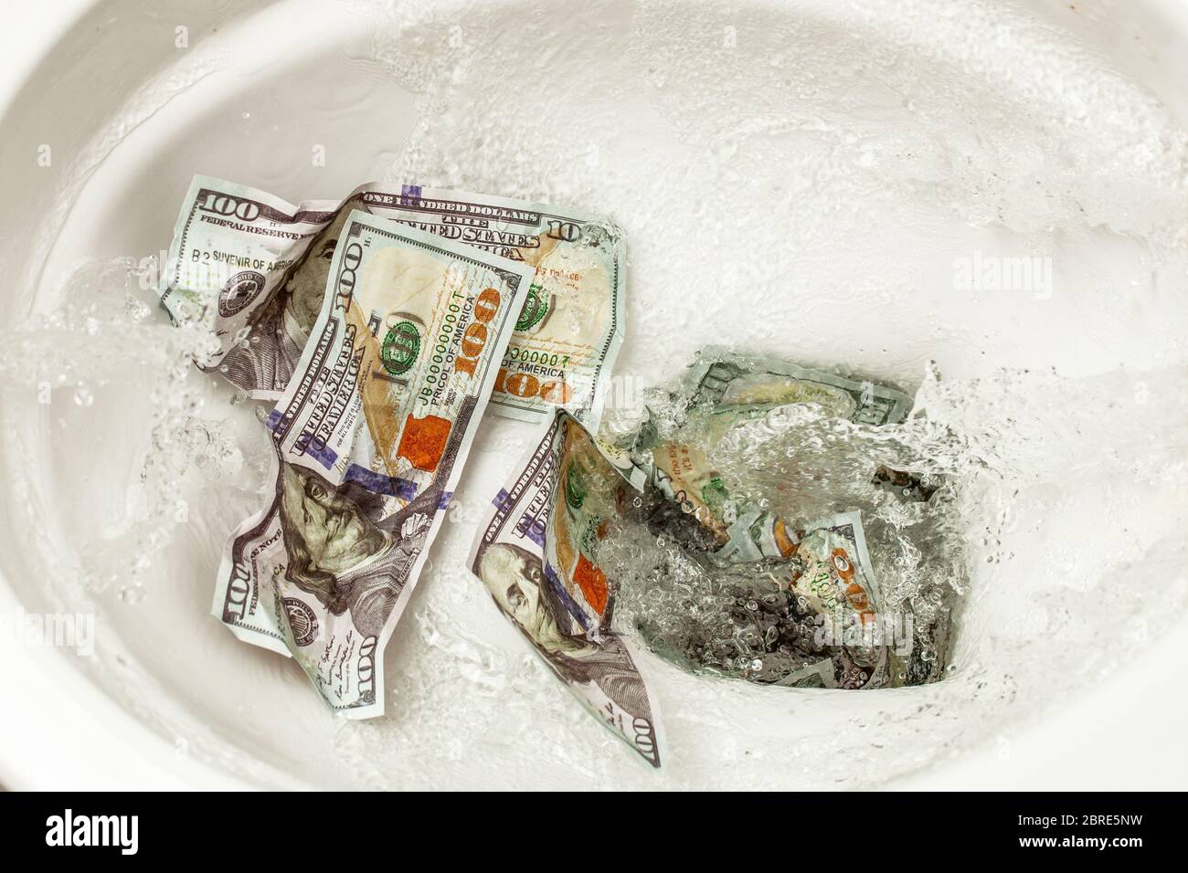 Flush money down the toilet hi-res stock photography and images - Alamy