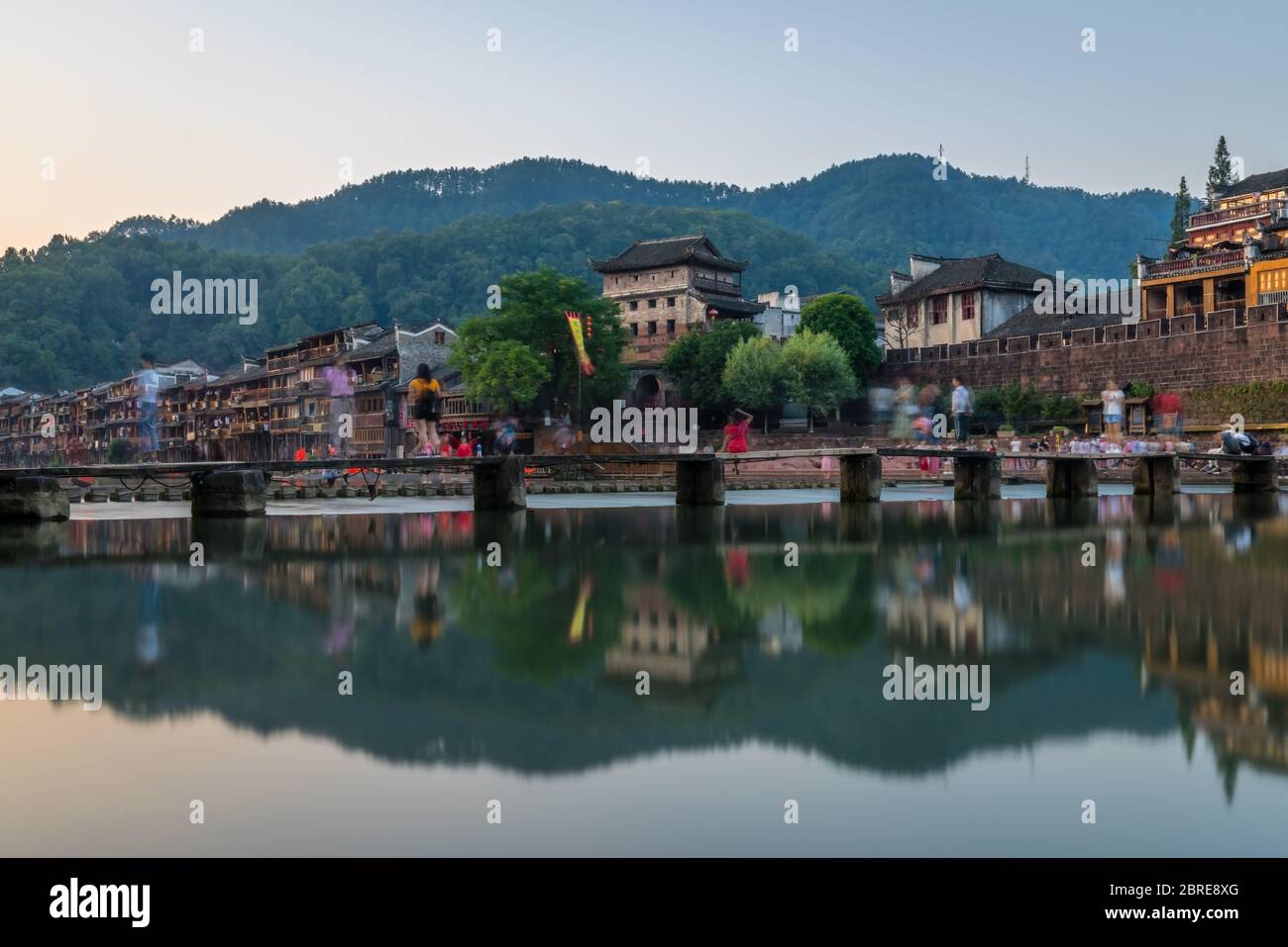 Feng Huang, China - August 2019 : People walking on the narrow wooden ...