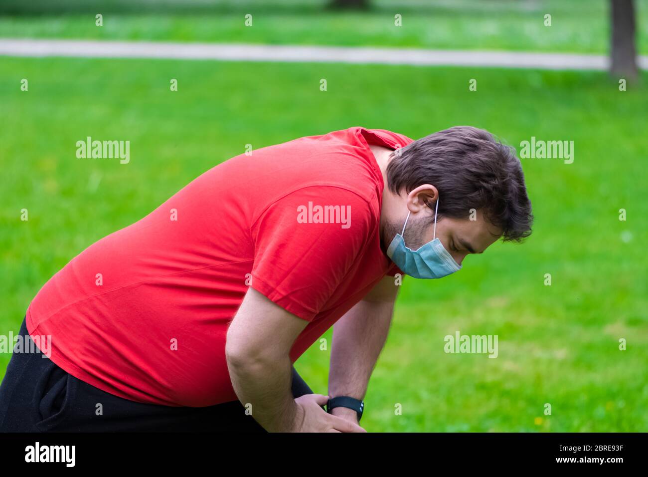 Fat man wearing face mask doing exercises after quarantine Stock Photo ...