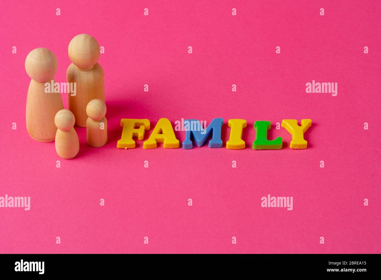 Wooden little figures of people. Family concept Stock Photo - Alamy