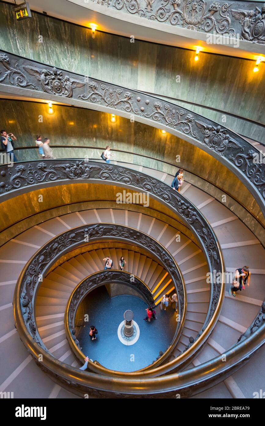 VATICAN - MAY 14, 2014: Tourists walk down the famous spiral staircase ...