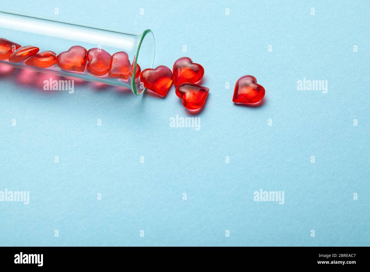 Hearts and test tube. Baby from tube vitro glass. Artificial ...