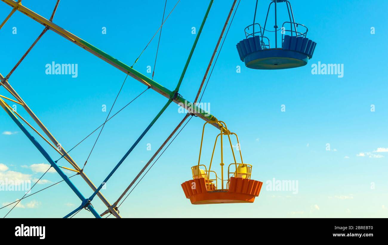 Ferris wheel cabins close-up on the blue sky background. Detail of the ...