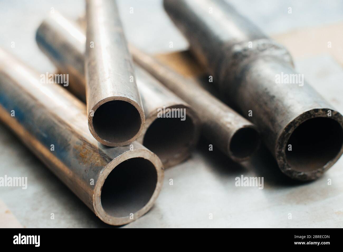 Stainless steel scrap metal, stainless steel pipes on the background of ...