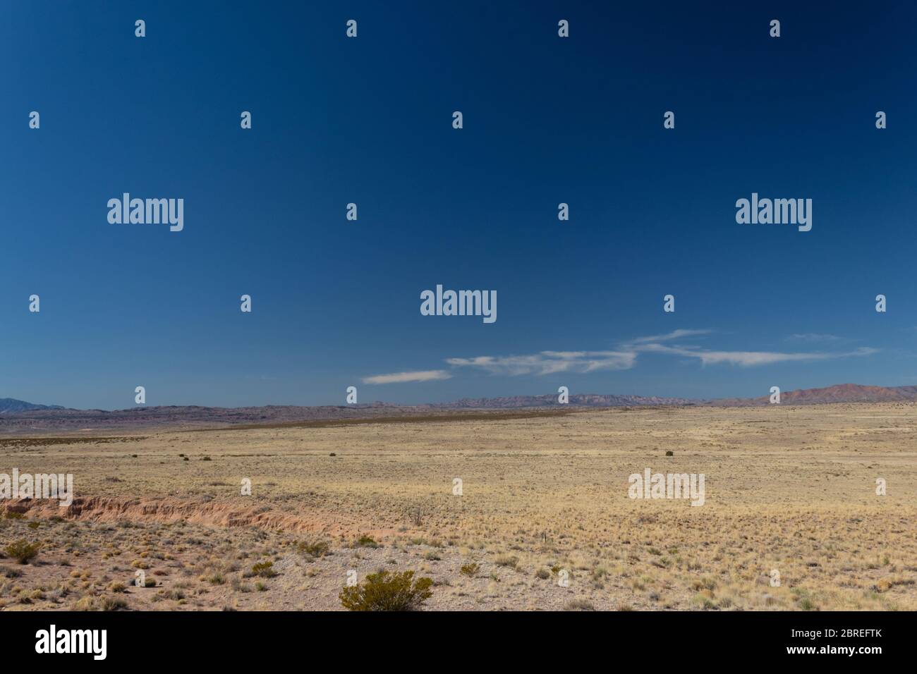 Far off view of distant mountains seen from across a vast desert ...