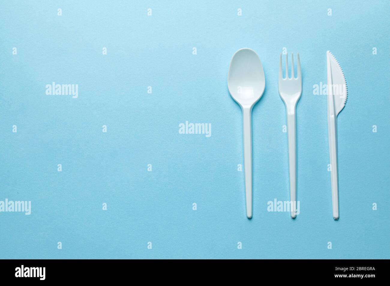 Plastic cutlery, forks, spoons and knives. Pollution of the environment ...