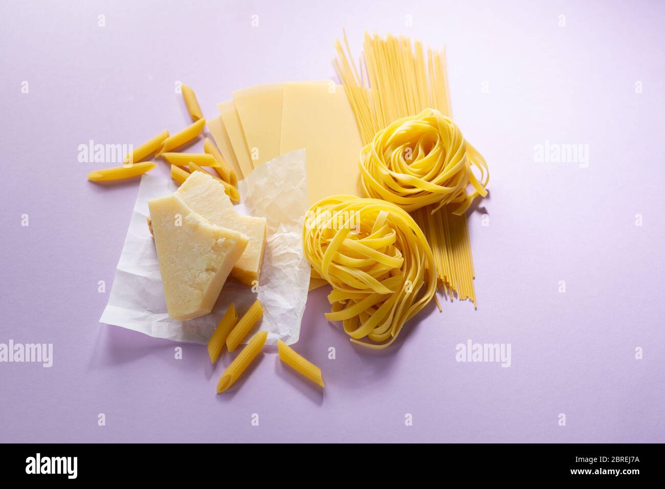 Uncooked pasta different types on color surface Stock Photo - Alamy