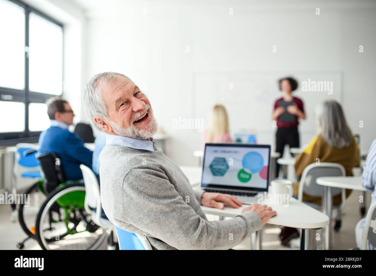 Portrait of senior man attending computer and technology education ...