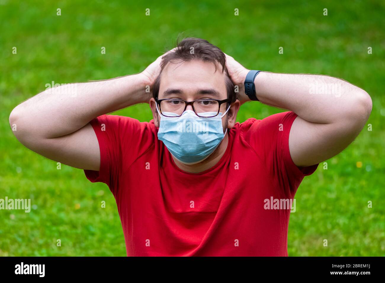 Fat man wearing face mask sitting on the grass Stock Photo - Alamy