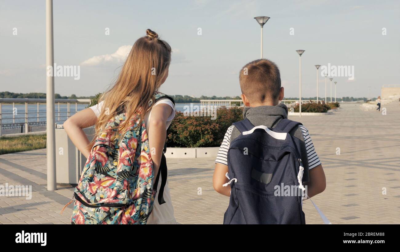 Kid girl and boy walking fast to school being late Stock Photo - Alamy