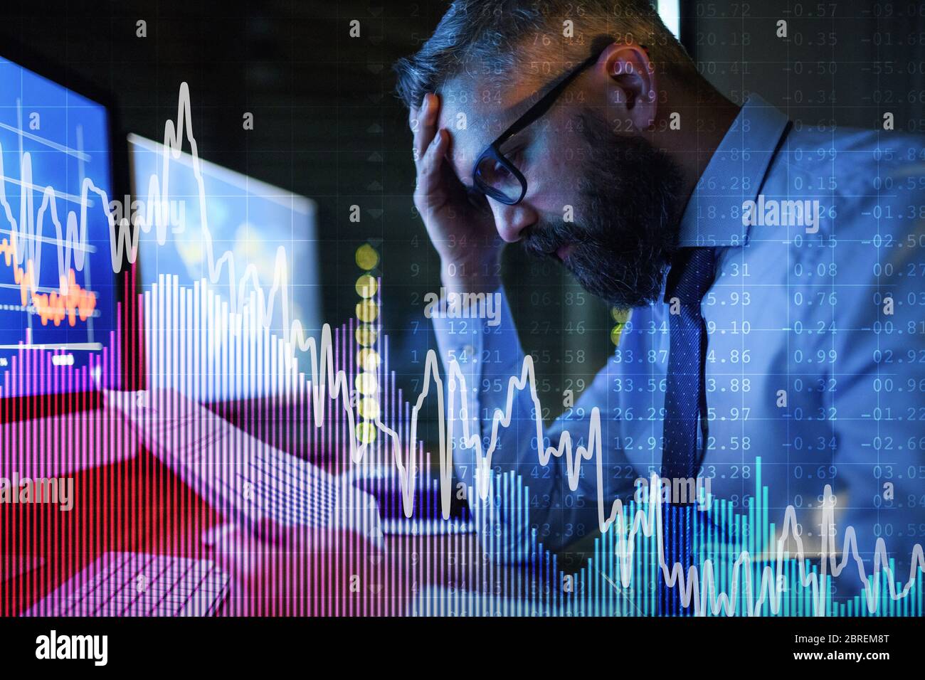Frustrated businessman with computer sitting at desk, financial crisis ...