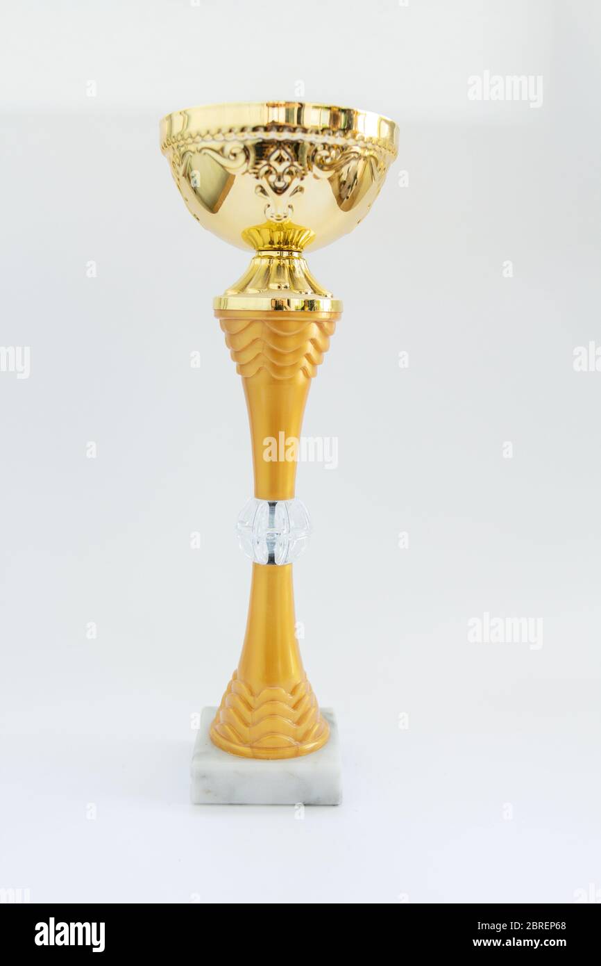 a golden winner cup on white background Stock Photo - Alamy