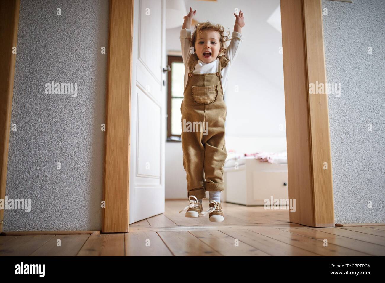 Small toddler girl jumping indoors at home, having fun Stock Photo - Alamy