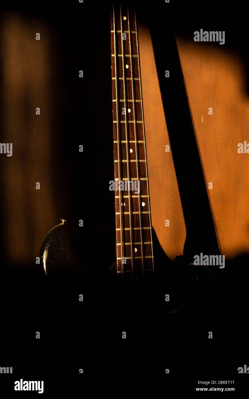 Bass guitar in music studio shot at golden hour Stock Photo - Alamy