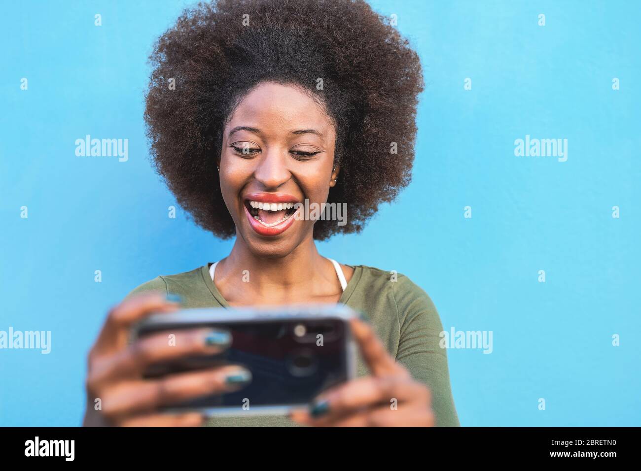 Young Afro woman using mobile smartphone - Happy African girl having ...