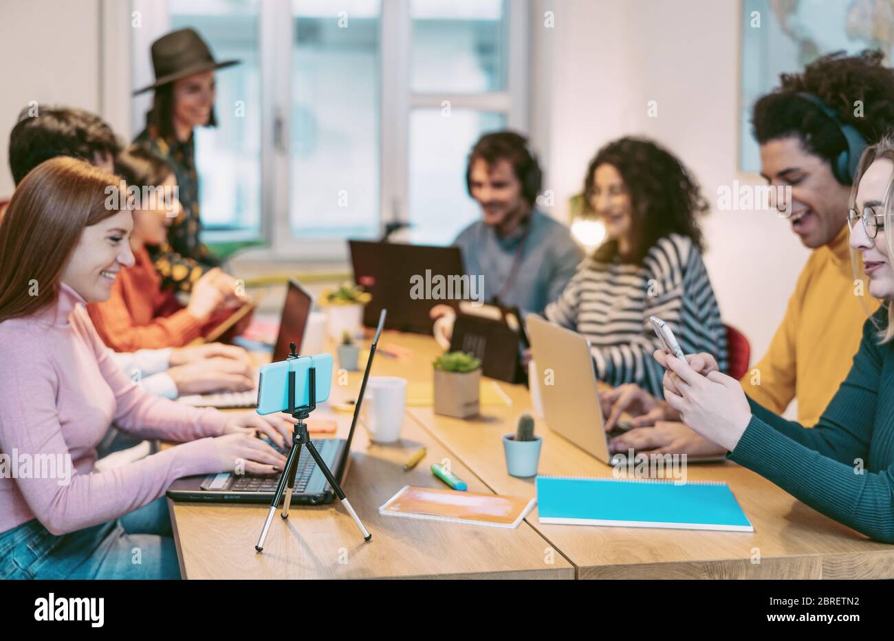 Happy young people working together inside office - Multiracial friends ...