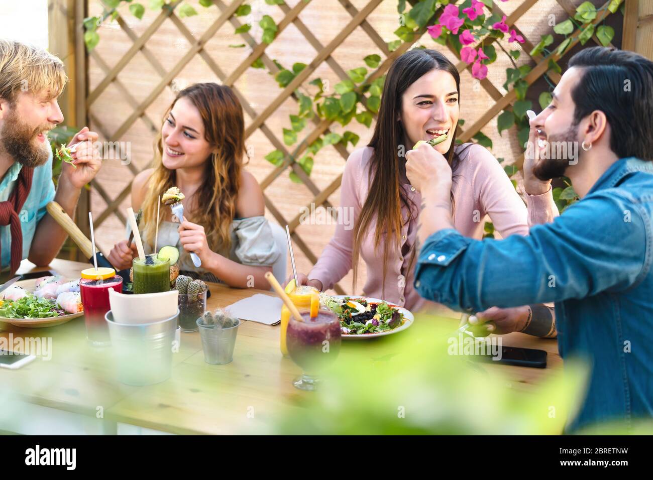 Happy friends lunching with healthy food in bar coffee brunch - Young ...