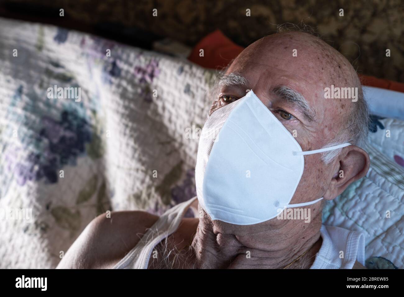 Contrast of old man with face mask, Spain, Europe Stock Photo - Alamy