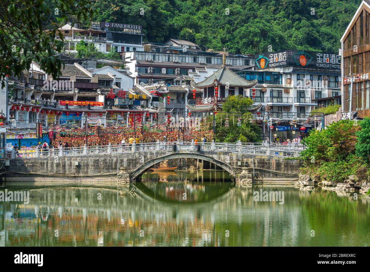 Yangshuo, China - August 2019 : Ancient arched bridge over the pond and ...