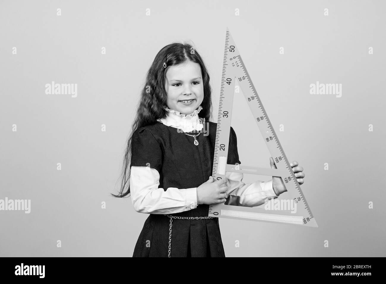 School student learning geometry. Pupil girl with big ruler. STEM ...