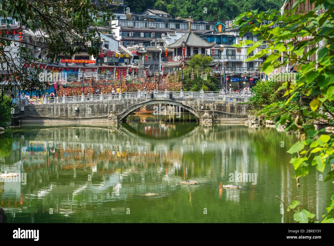 Yangshuo, China - August 2019 : Ancient arched bridge over the pond and ...