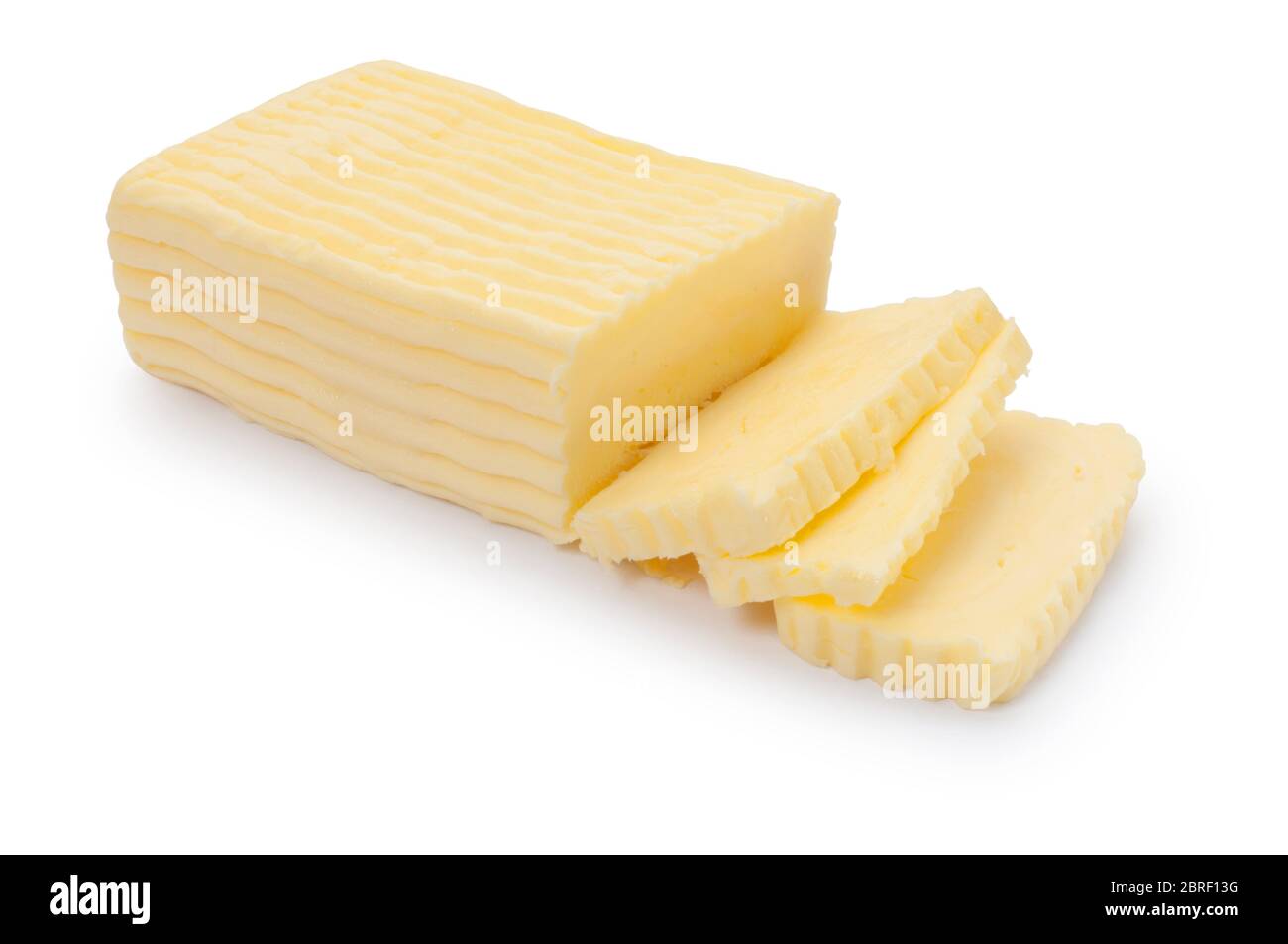 Studio shot of block of rich, creamy butter cut out against a white ...