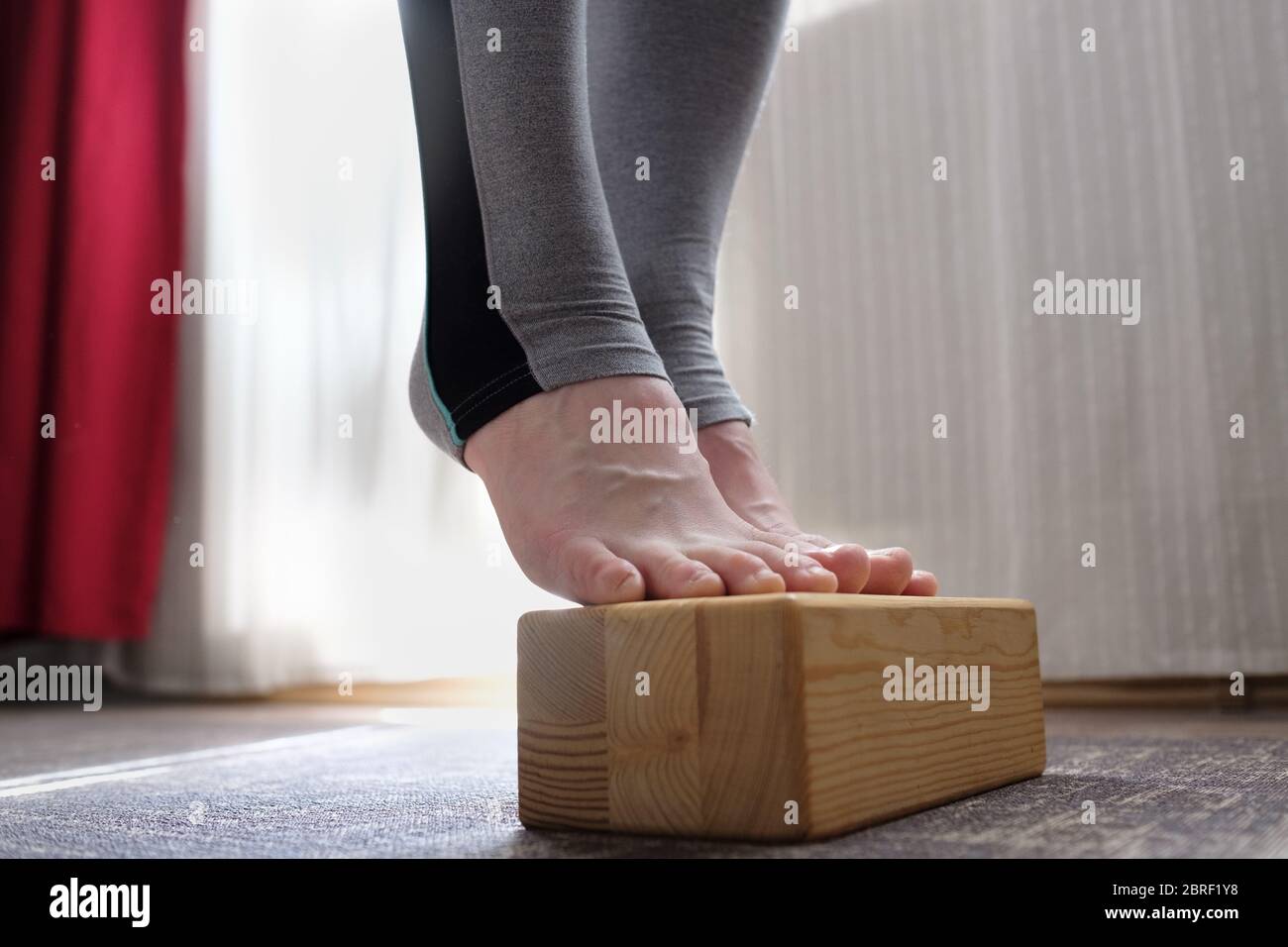 Woman doing exercise for strong foot using wooden props Stock Photo - Alamy