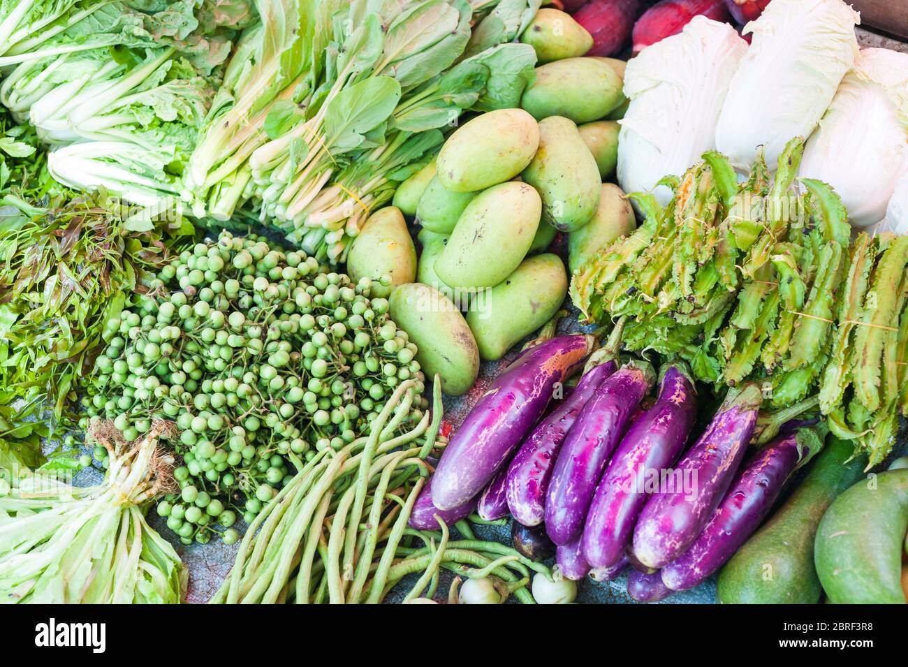 Eggplants, mangoes, beans and other vegetables for sale at Psar Nat ...