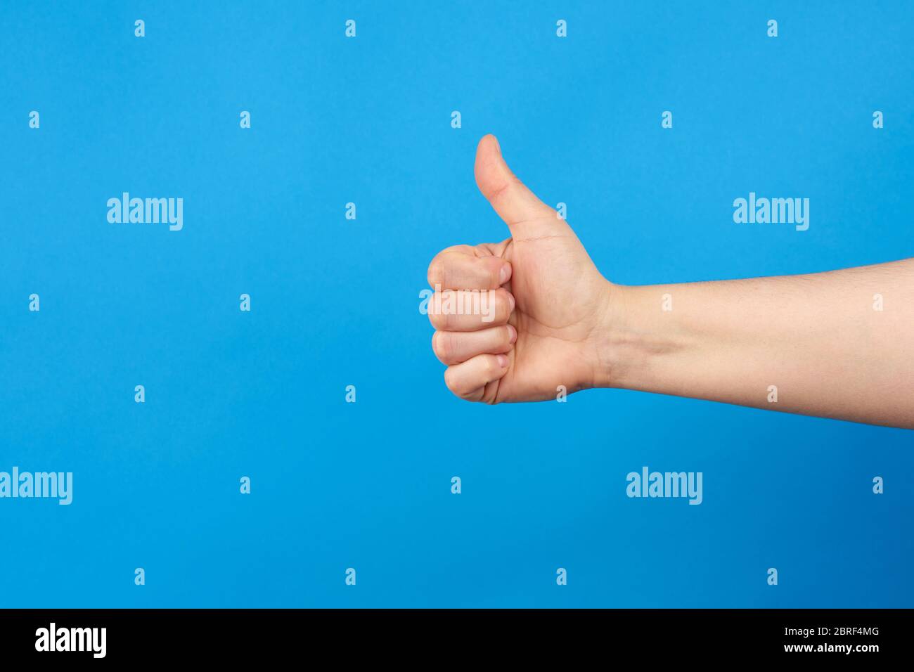 female hand shows right-handed gesture like on a blue background ...