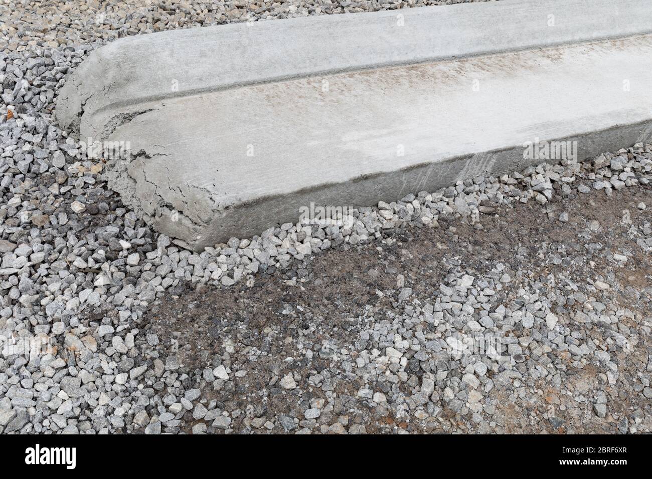 Closeup view of the end of a section of extruded concrete curbing on a ...